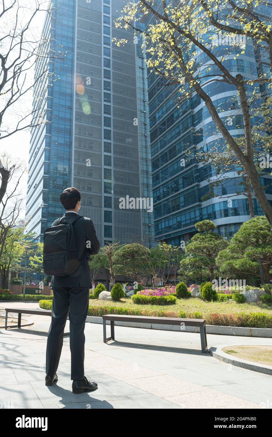 young Asian handsome man looking at city buildings Stock Photo - Alamy