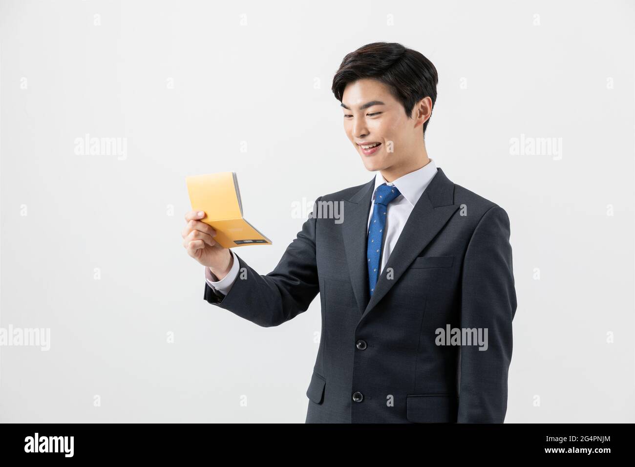 happy Asian man checking his balance in bank book Stock Photo - Alamy