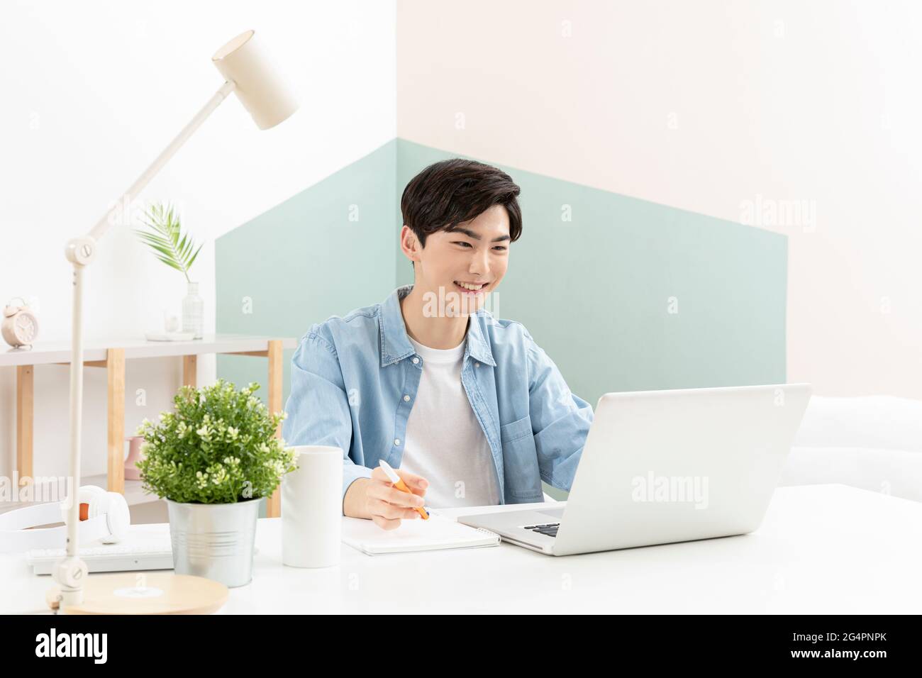 Asian handsome young man studying using laptop, online class concept ...