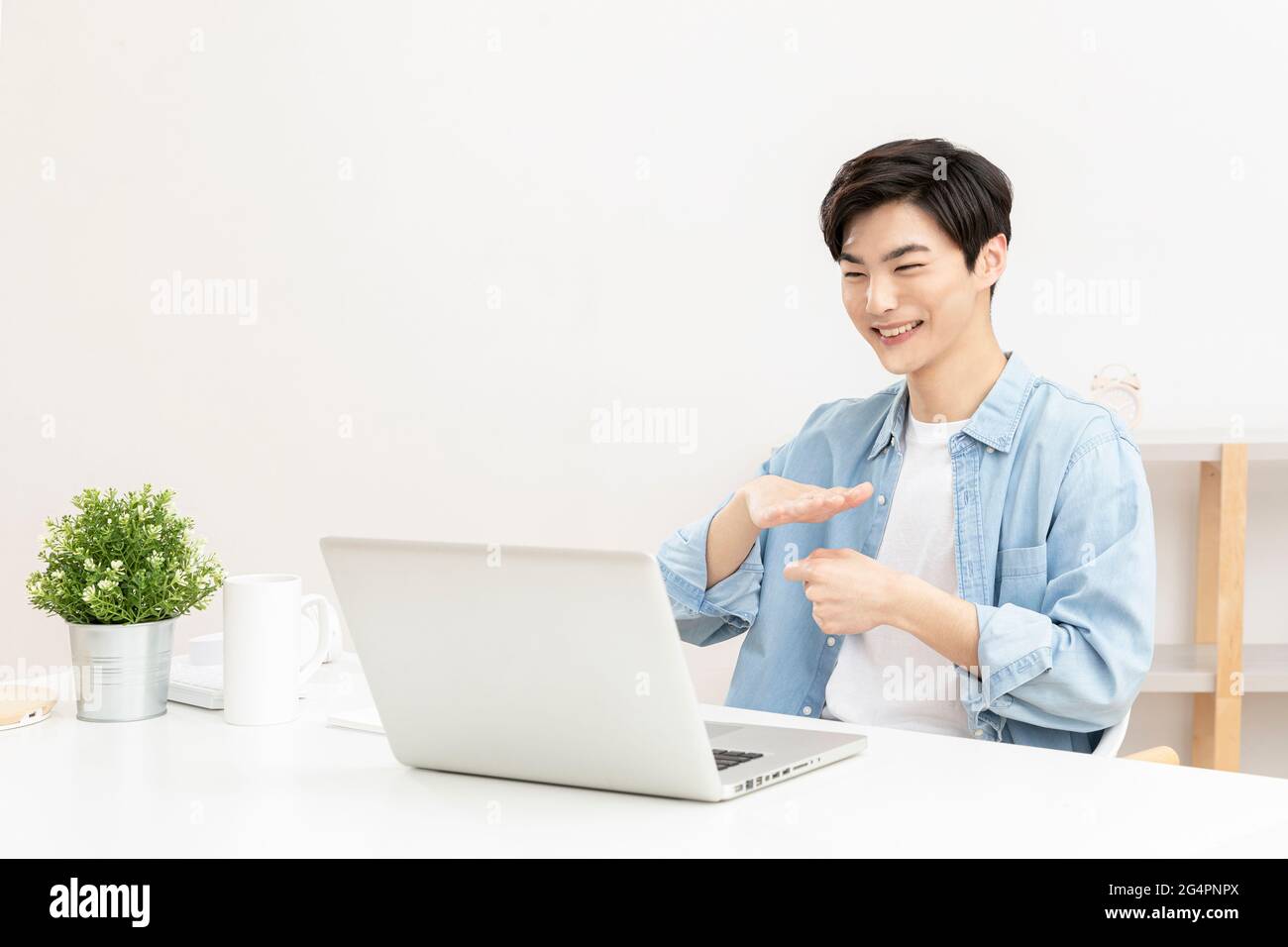 Asian handsome young man learning sign language through online class ...