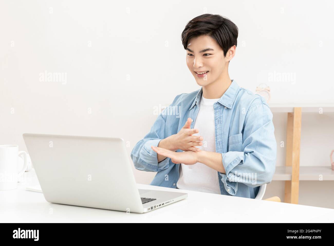 Asian handsome young man learning sign language through online class ...