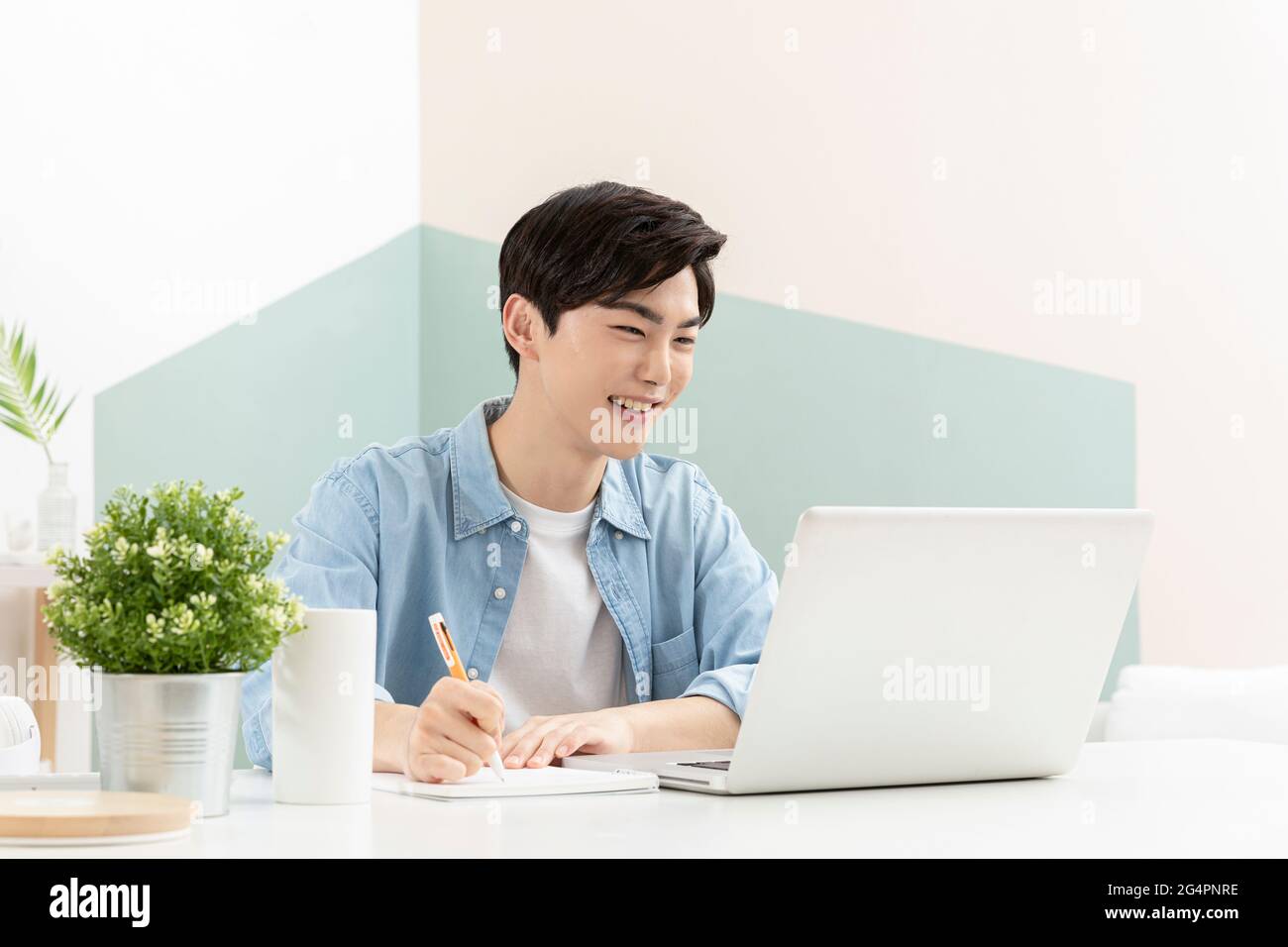 Asian handsome young man studying using laptop, online class concept ...
