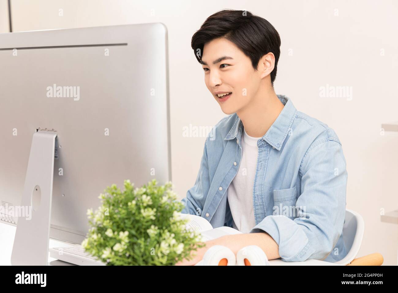 young Asian Korean man focused on computer monitor Stock Photo - Alamy