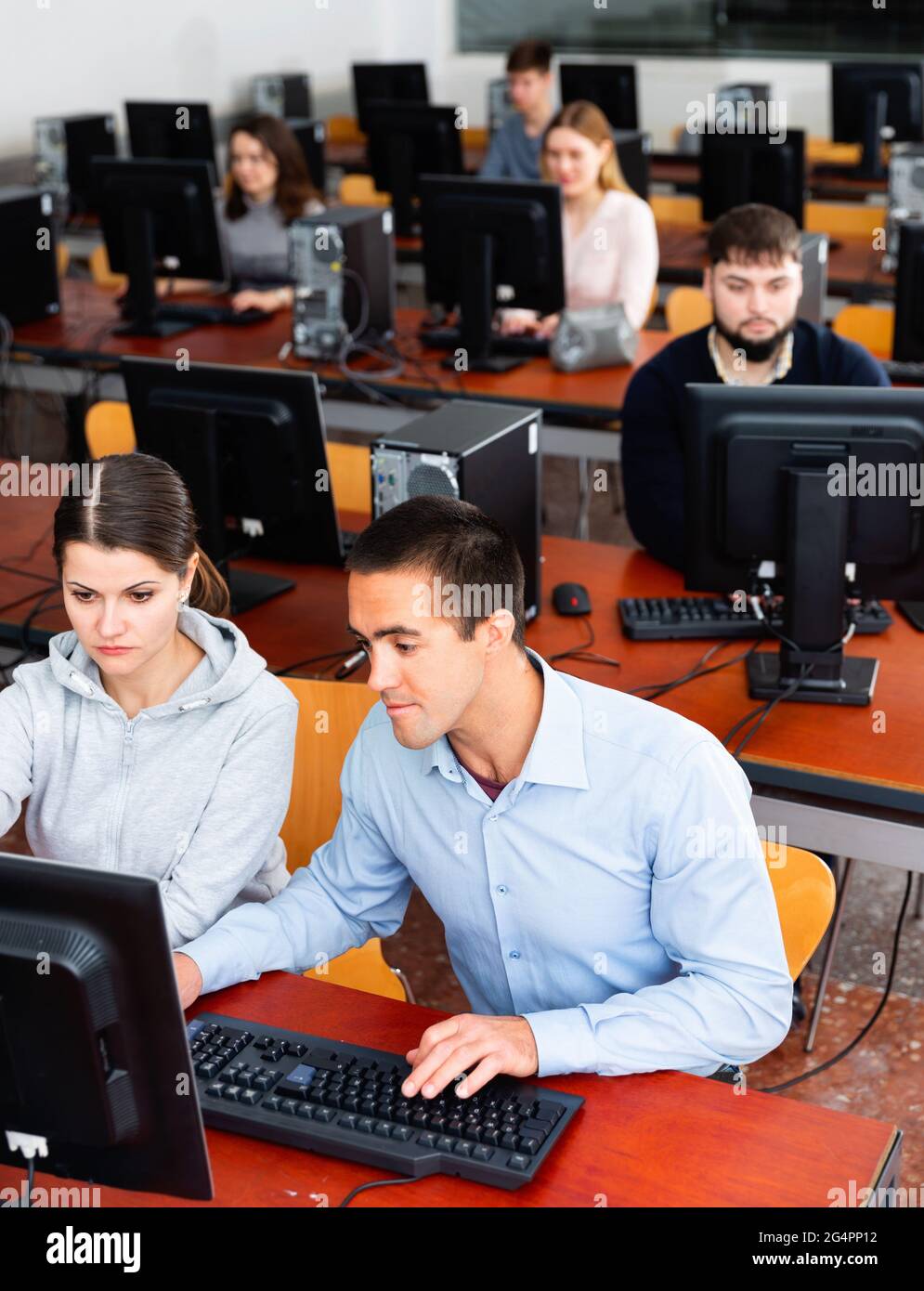 Computer Science Teacher Supervises The Execution Of A Programming Task In A Computer Class