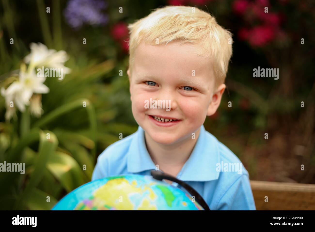 Selective focus of an adorable blue-eyed Australian cheerful young boy ...