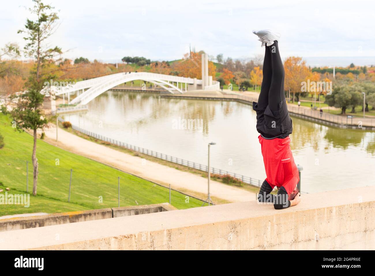 Man doing headstand exercise outdoors in a park Stock Photo - Alamy