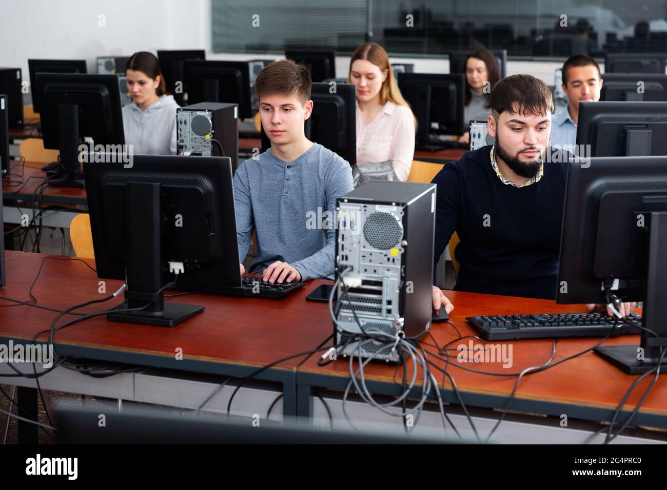 Group of people learning to use computers in classroom Stock Photo - Alamy