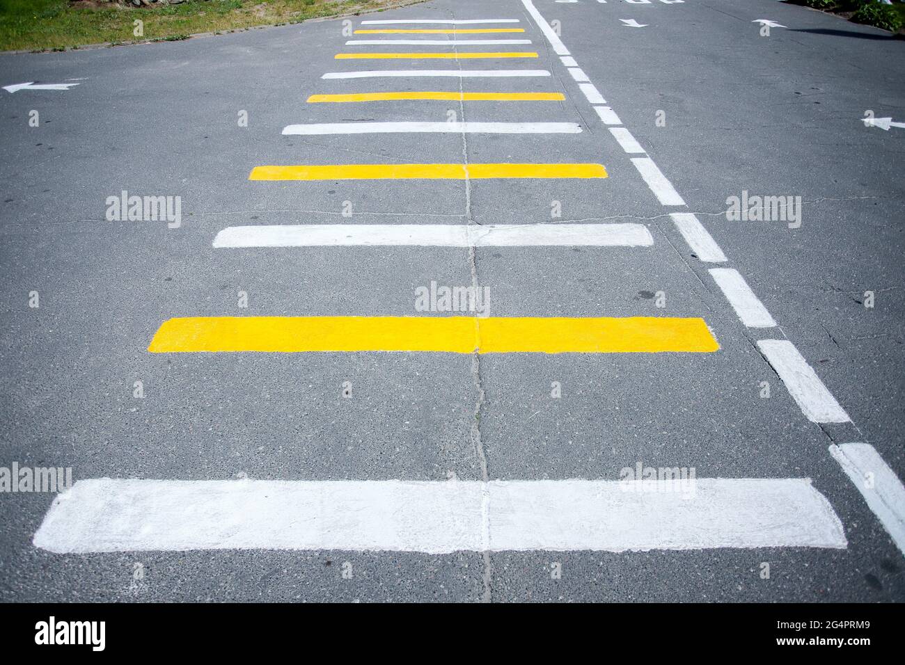 Pedestrian crossing, white-yellow stripes on a road Stock Photo - Alamy