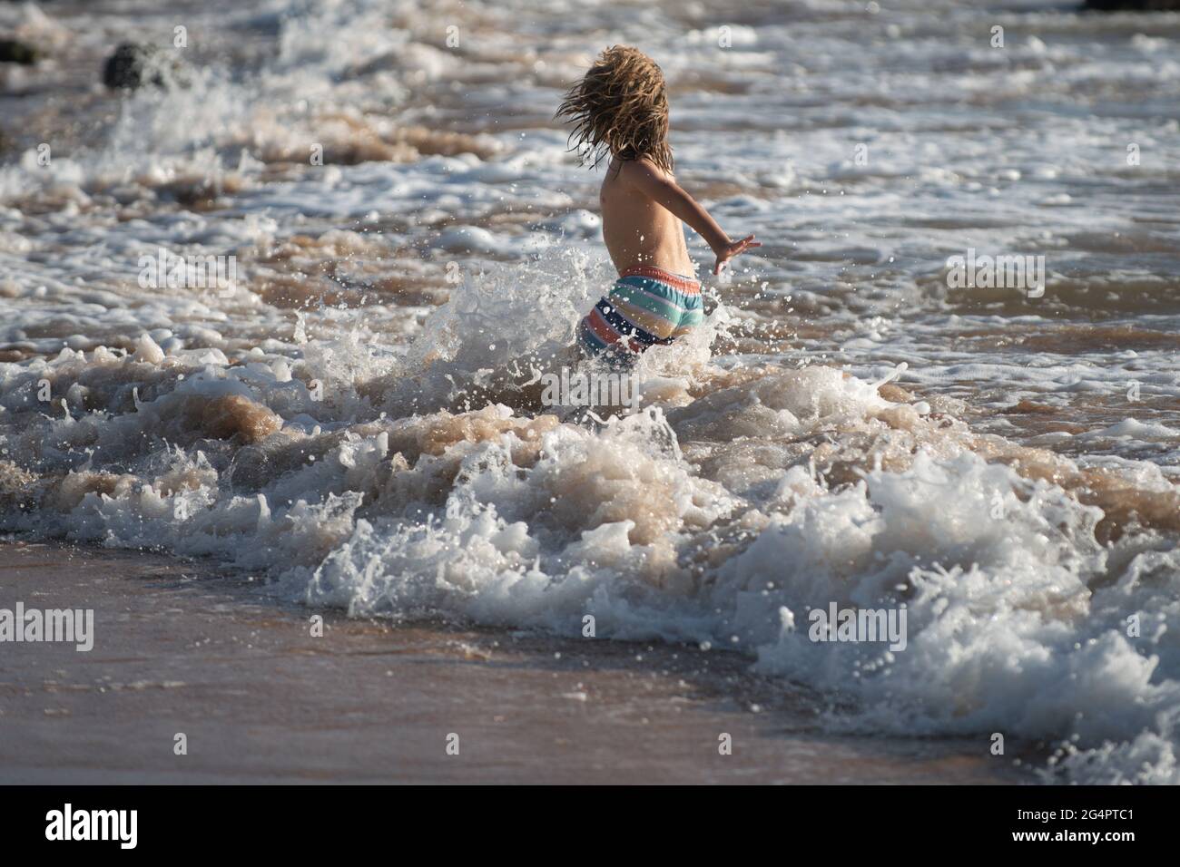 Kids jumping waves hi-res stock photography and images - Alamy
