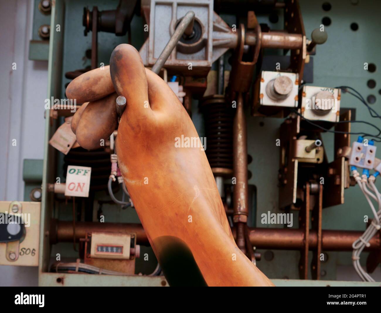Asian boy Gloves hand holding electric switch at supply unit ...