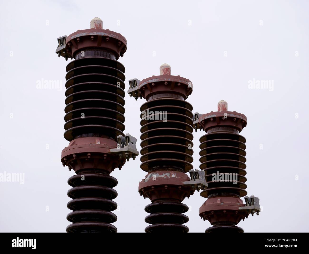 Industrial electric supply Three heavy fuse tube on sky background ...