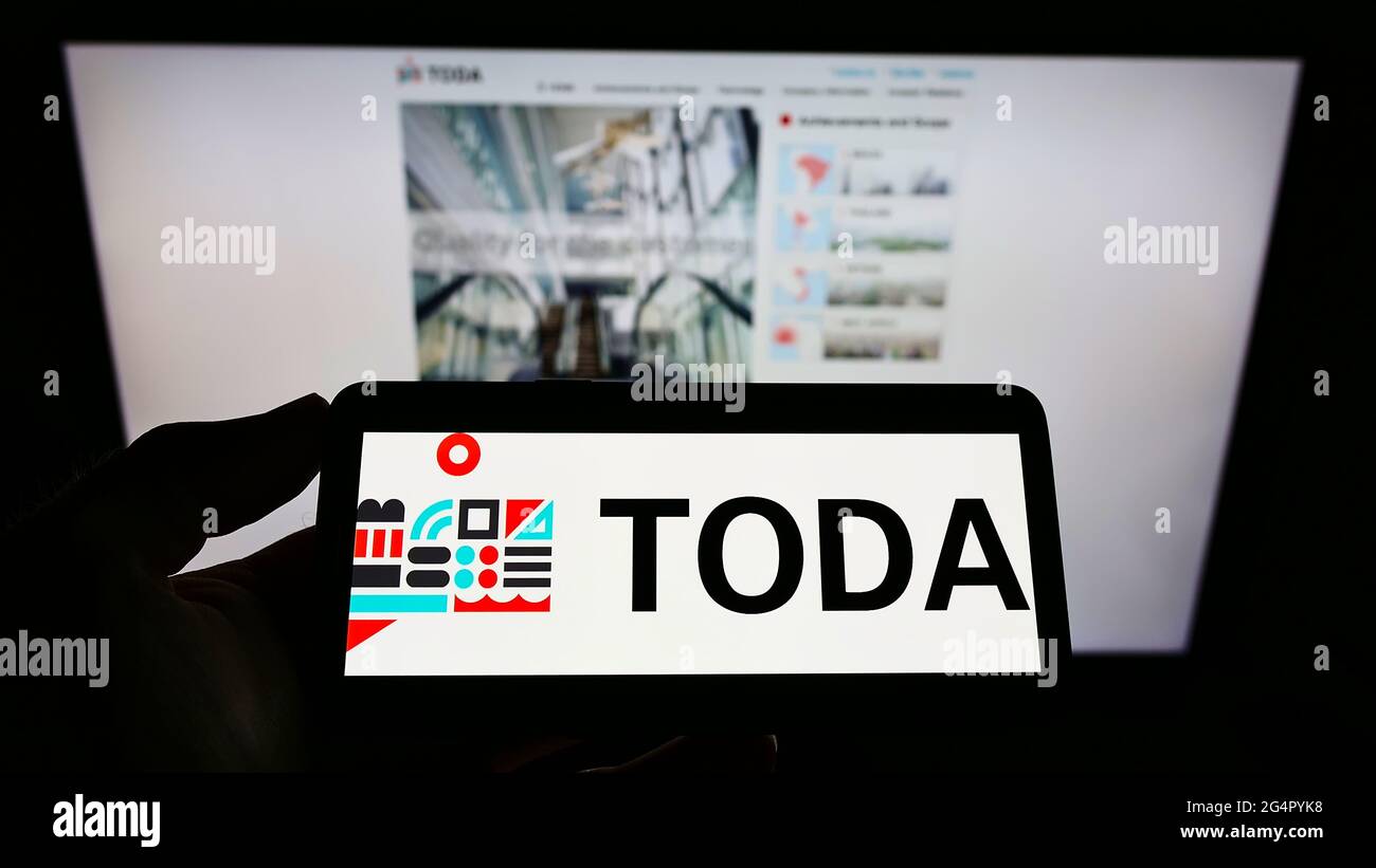 Person holding cellphone with logo of Japanese construction company ...