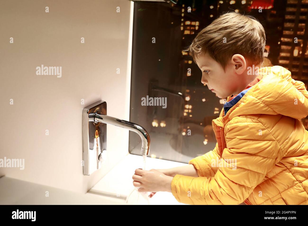Boy washing his hands in a restroom Stock Photo - Alamy