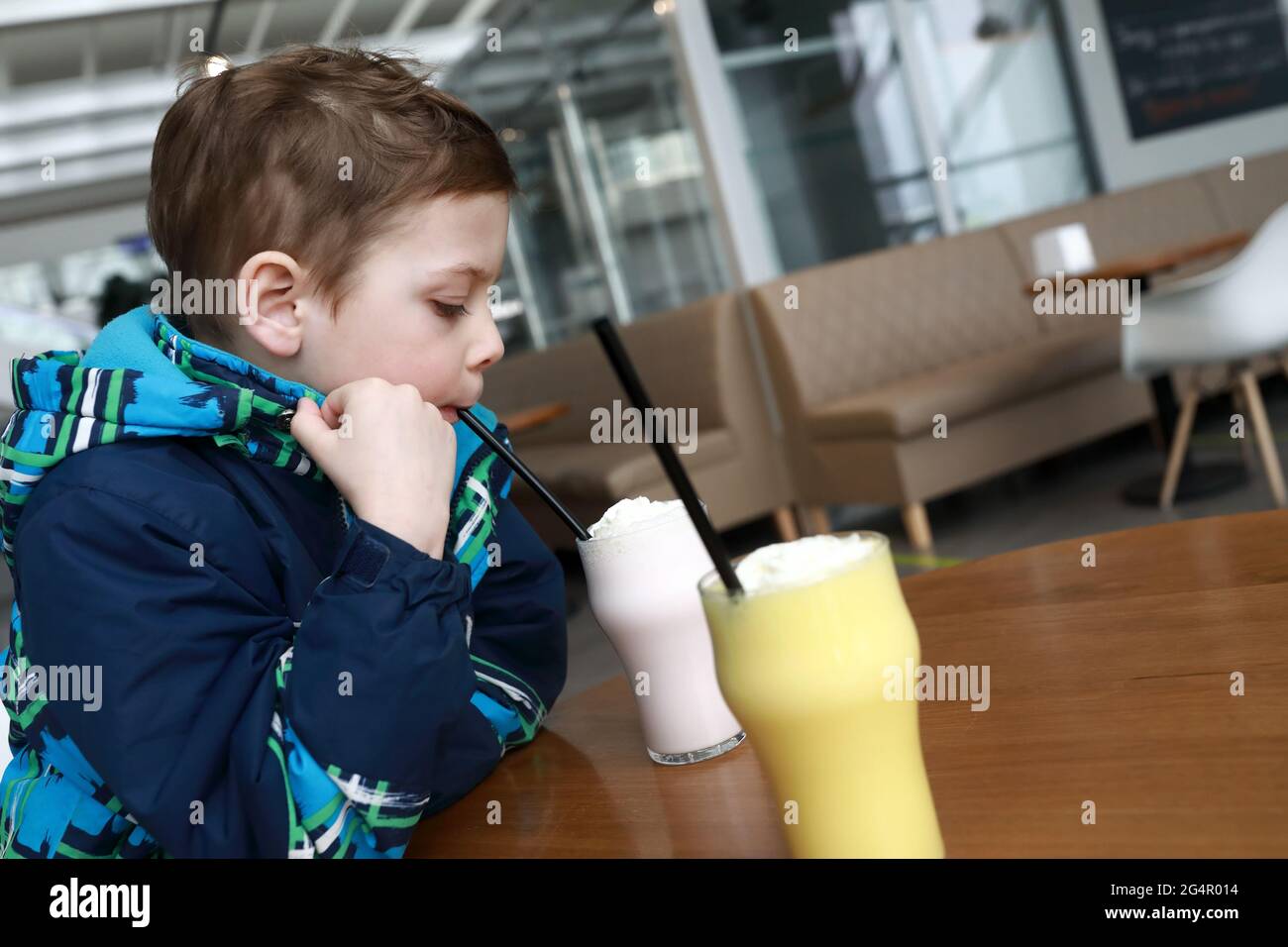 Child drinking milk shake in a restaurant Stock Photo - Alamy