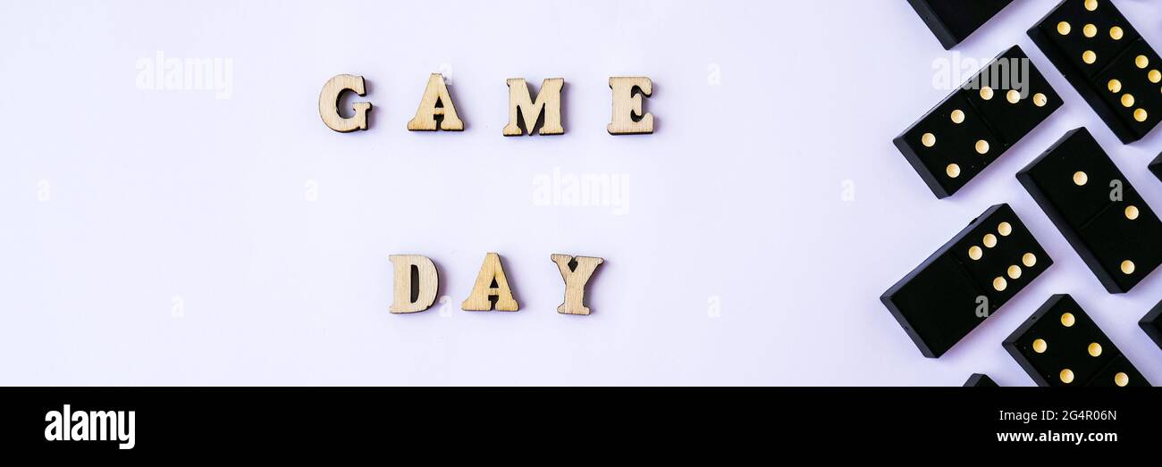 Text GAME DAY on white background with dominoes dice. Table game. Jomo ...