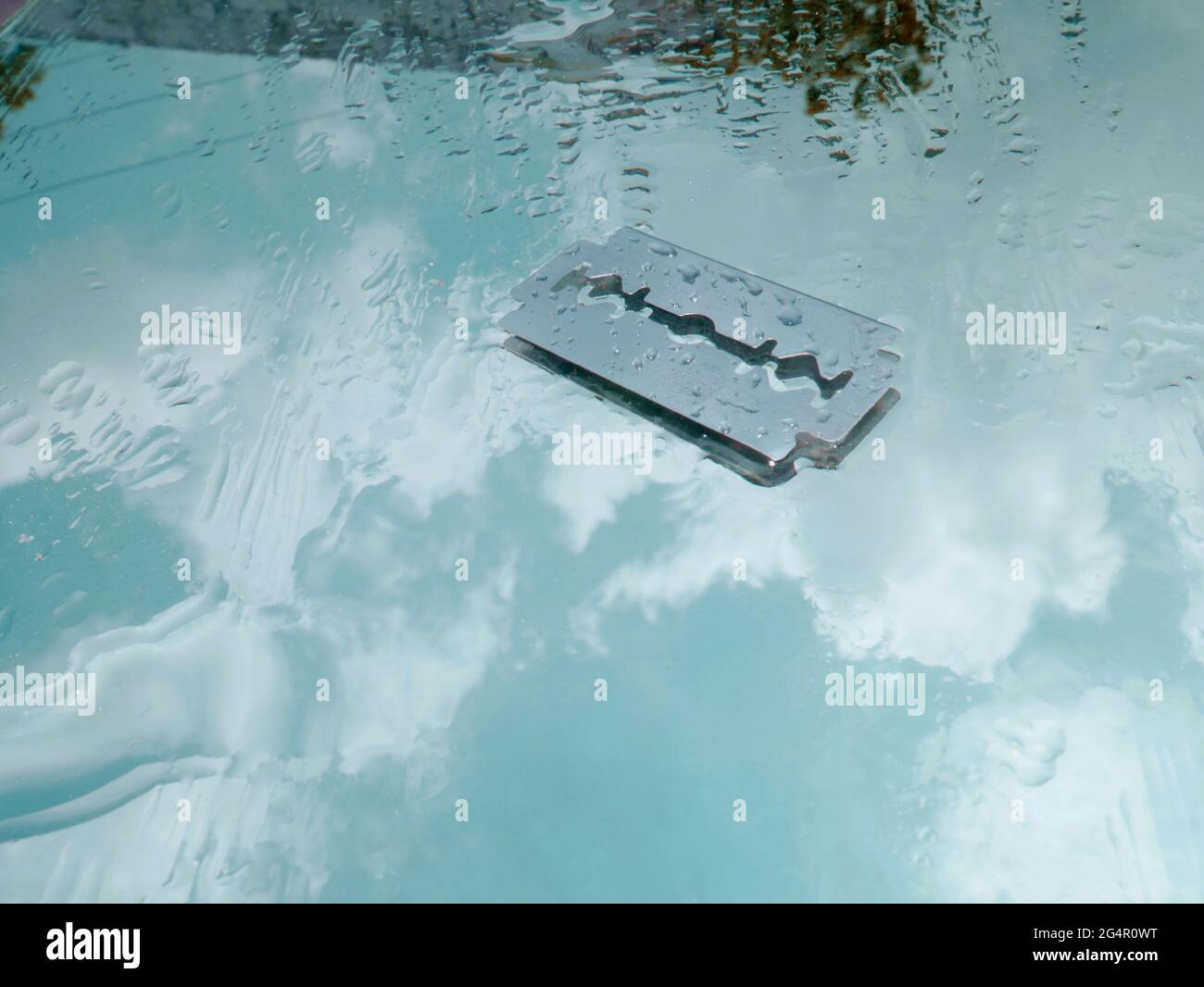 Shaving blade metal presentation on glass with sky reflection Stock ...