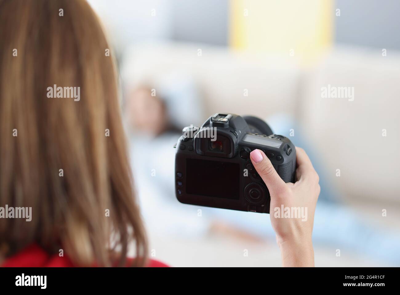 Black modern camera in female hand closeup Stock Photo - Alamy