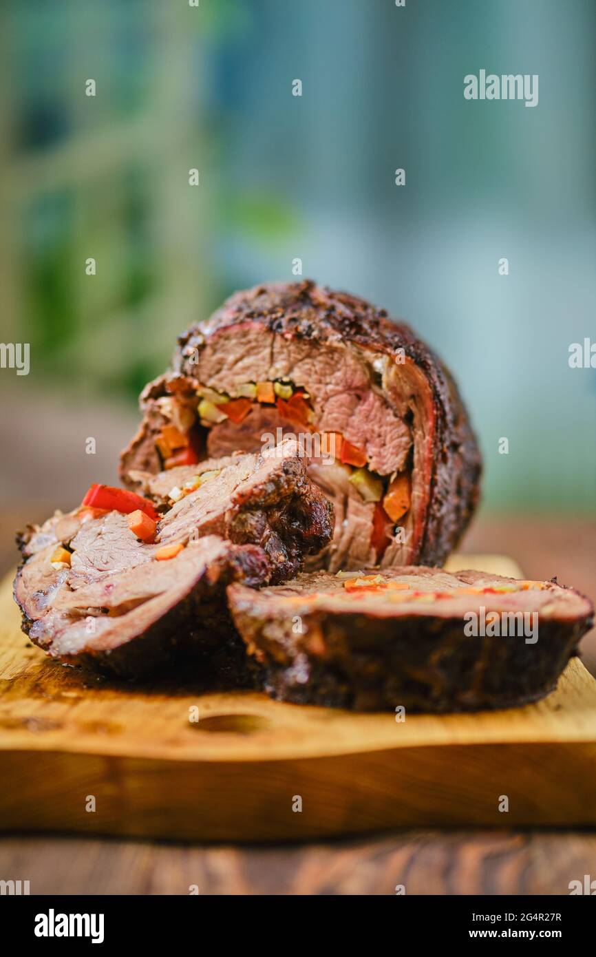 Baked beef roll with vegetables (focus on foreground Stock Photo - Alamy