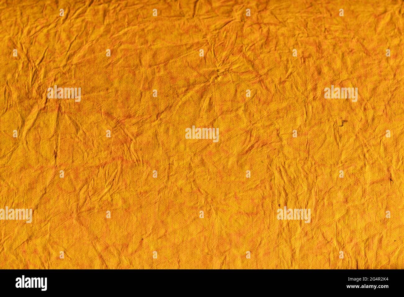 Background with yellow colour crushed paper Stock Photo - Alamy