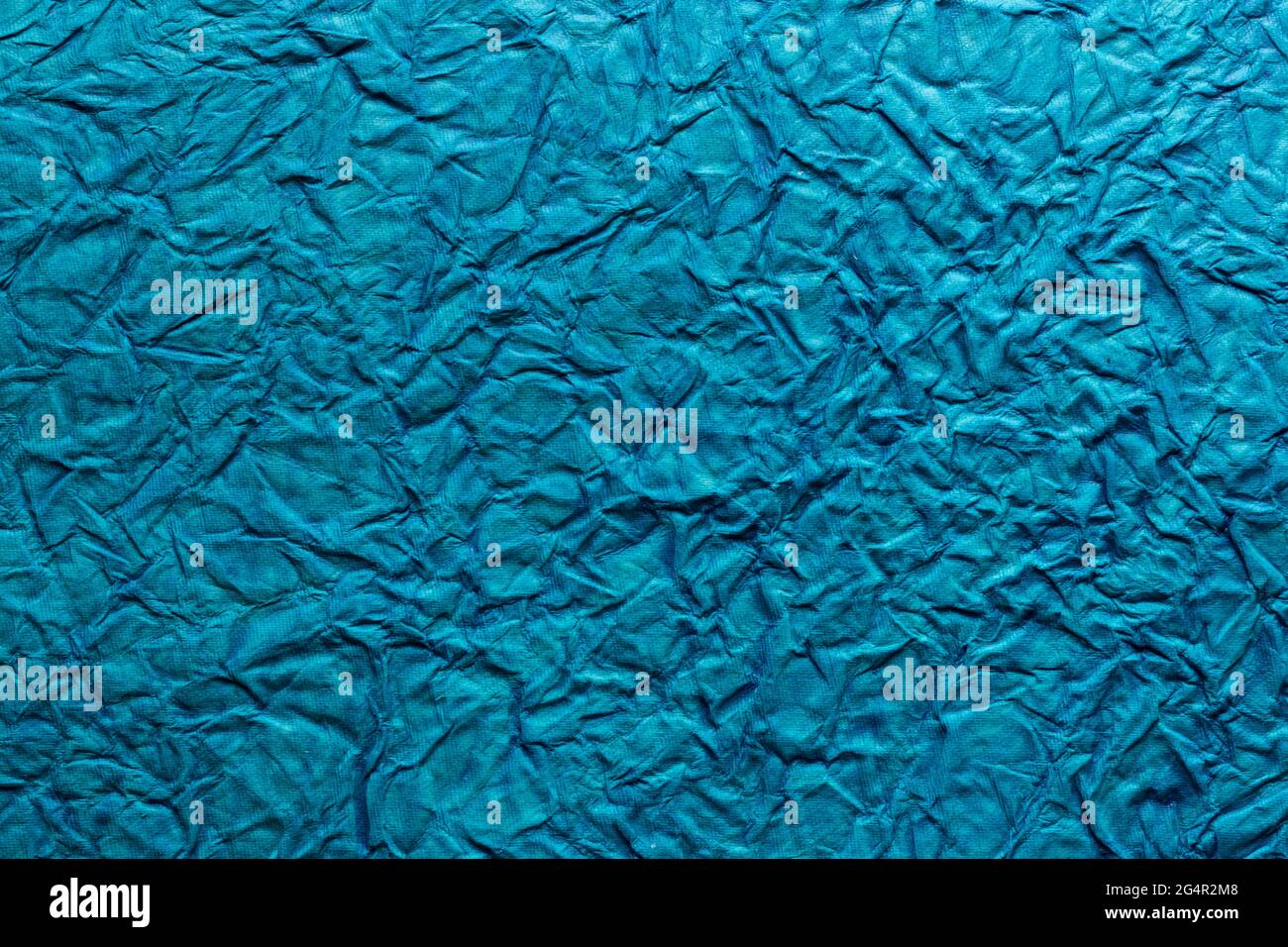 Background with blue colour crushed paper Stock Photo - Alamy