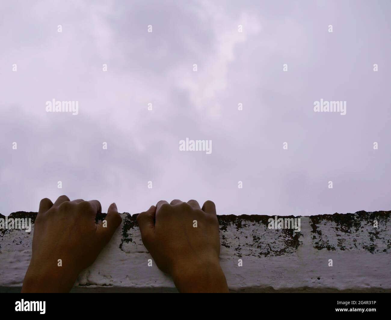 Boy hand holding constructed roof at sky background Stock Photo - Alamy