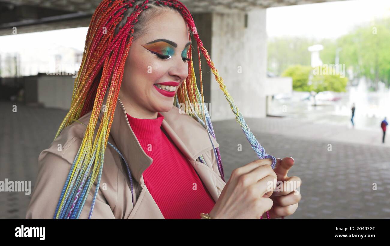 Fashionable girl in an elegant beige jacket with multi-colored African ...