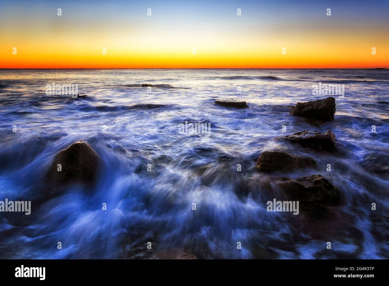 Hot red rising sun over Pacific ocean horizon off Newport Beach of ...