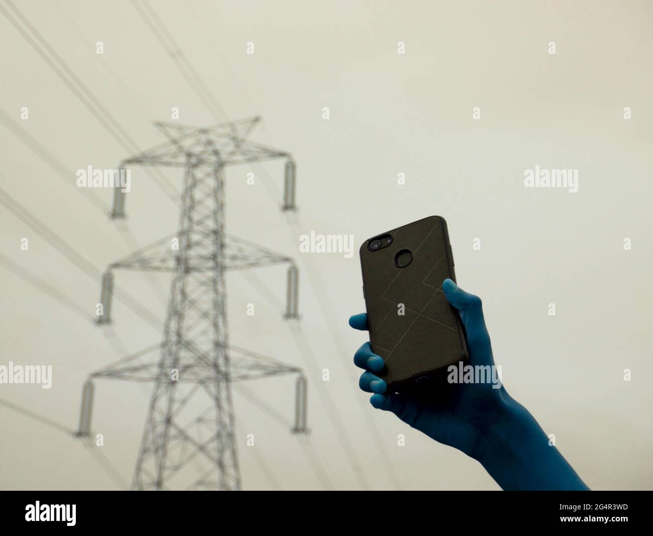 Boy hand holding smart phone behind blur tower sky backdrop, technology ...