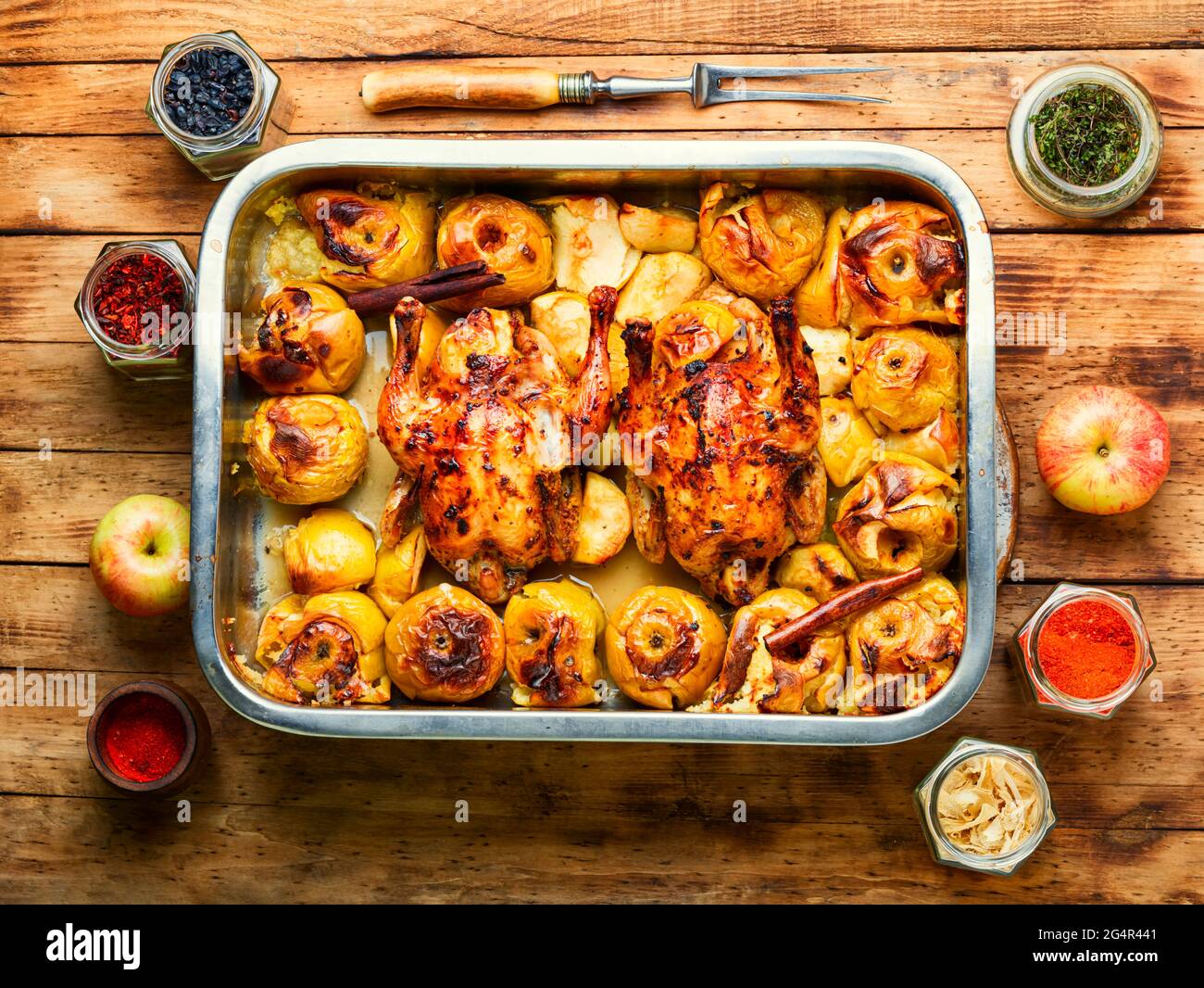 Delicious baked partridge with apples in an iron tray Stock Photo - Alamy