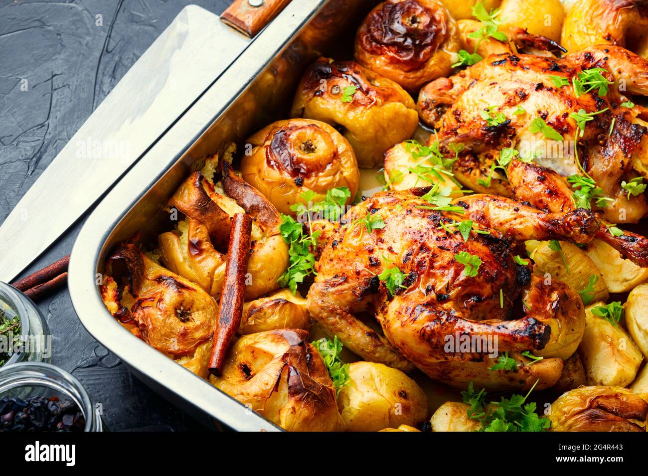 Delicious baked partridge with apples in an iron tray Stock Photo - Alamy