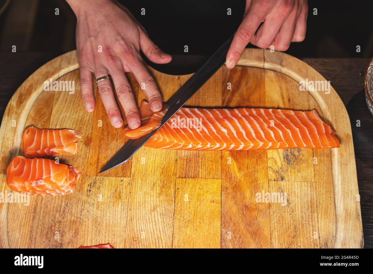 Hands slicing raw fish hi-res stock photography and images - Alamy