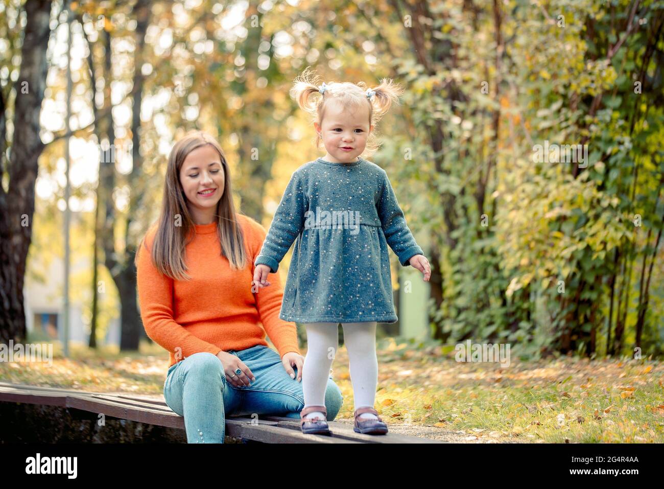 cute baby girl with mom in the park. beautiful autumn in the park Stock ...