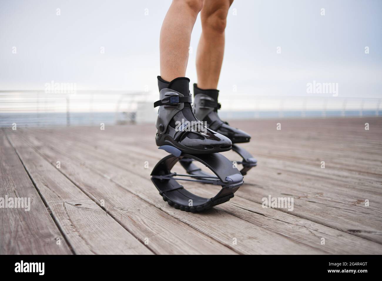 Female cropped legs with jumping shoes on the beach Stock Photo - Alamy
