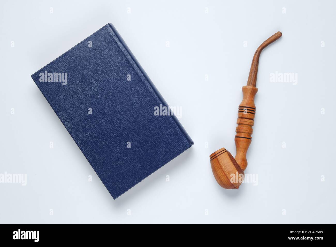 Vintage style. Old book, smoking pipe on yellow background. Top view ...