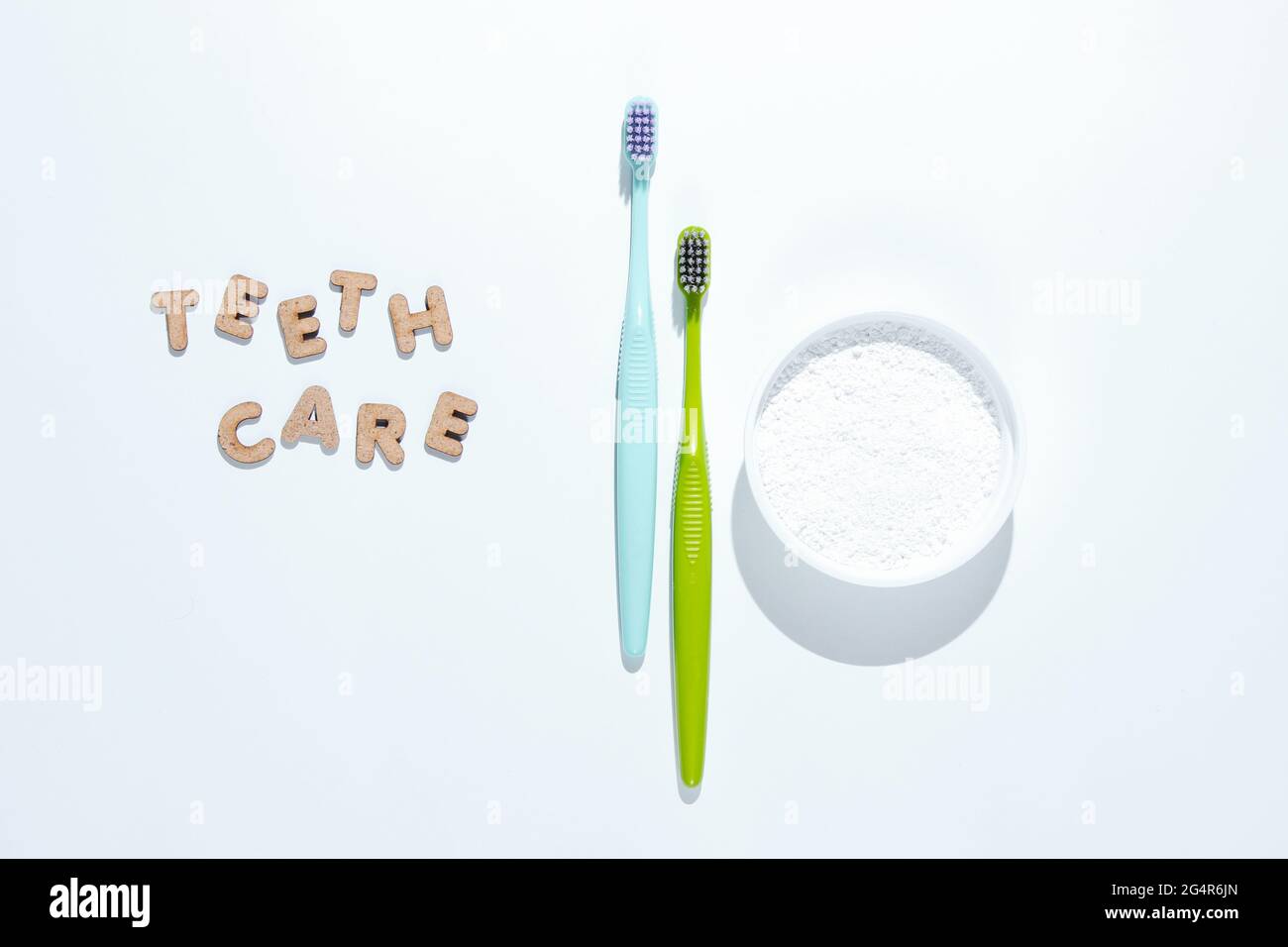 Two toothbrushes, tooth powder on white background with slogan teeth ...