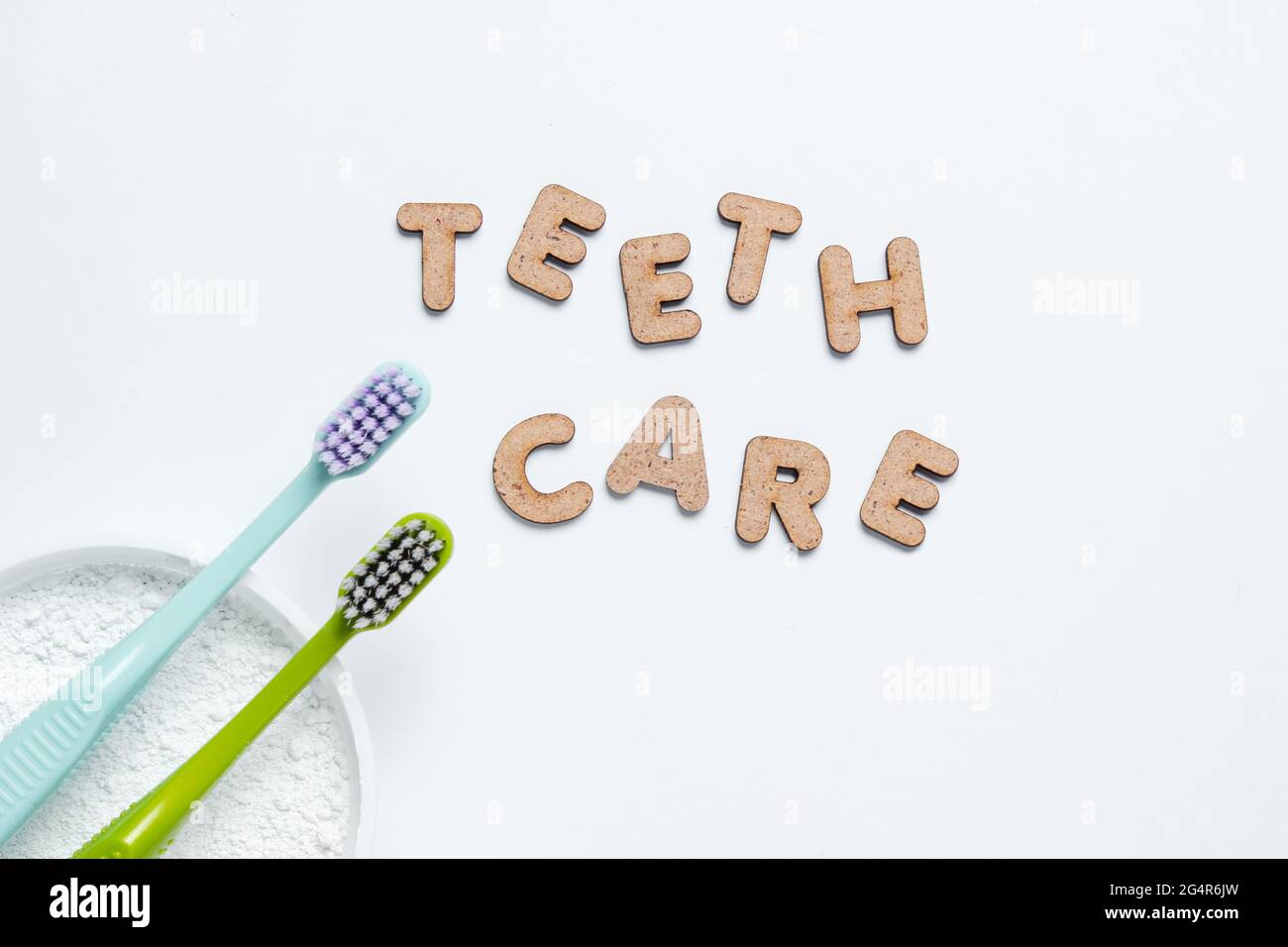 Two toothbrushes, tooth powder on white background with slogan teeth ...