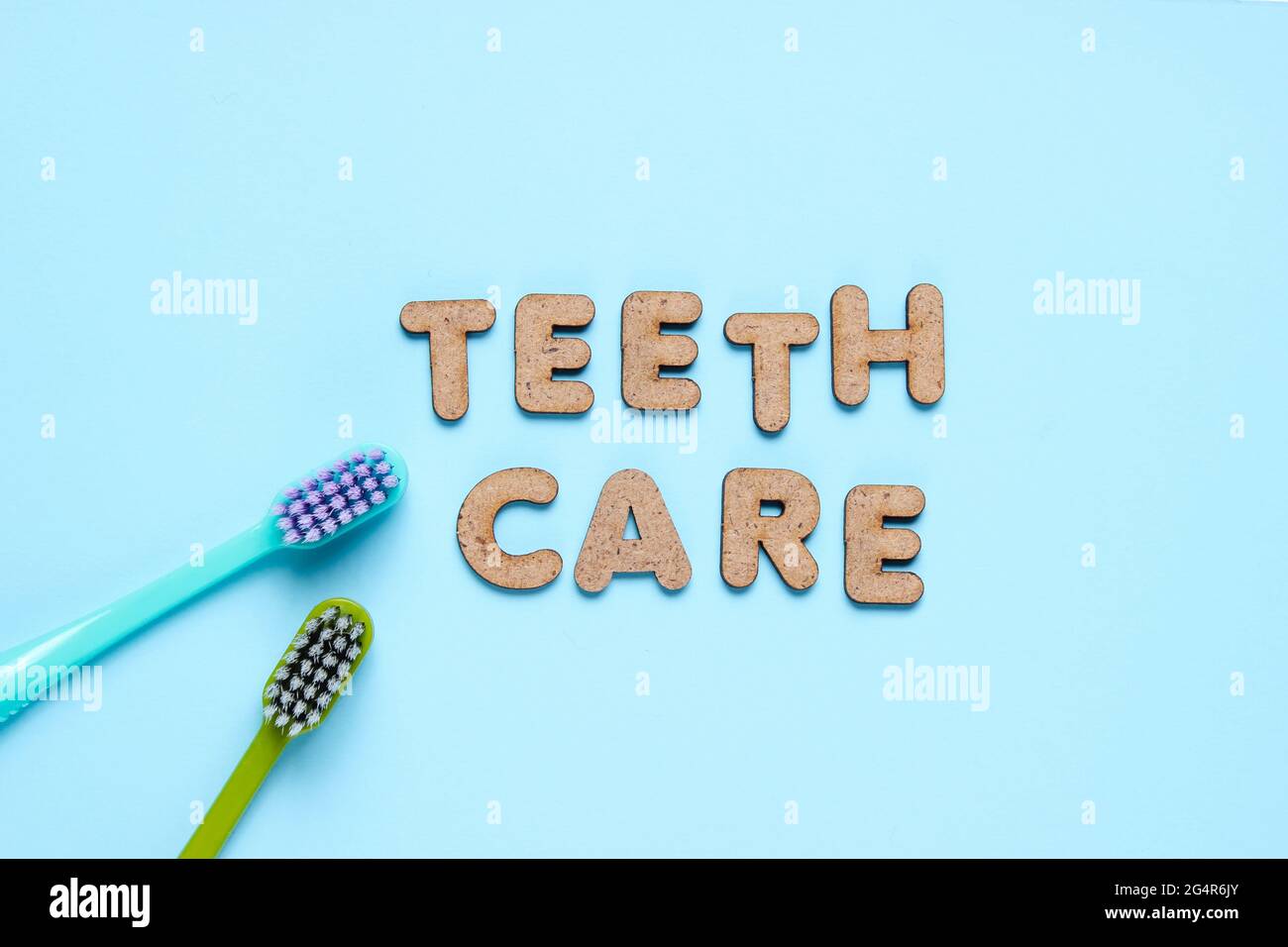 Two toothbrushes on blue background with slogan teeth care. Minimalism ...