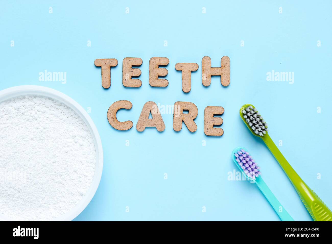 Two toothbrushes, tooth powder on blue background with slogan teeth ...