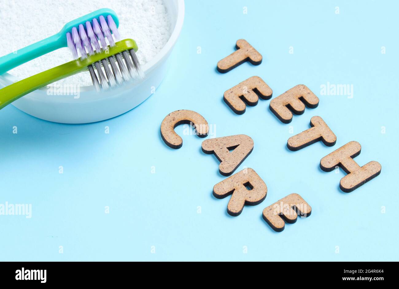 Two toothbrushes, tooth powder on blue background with slogan teeth ...
