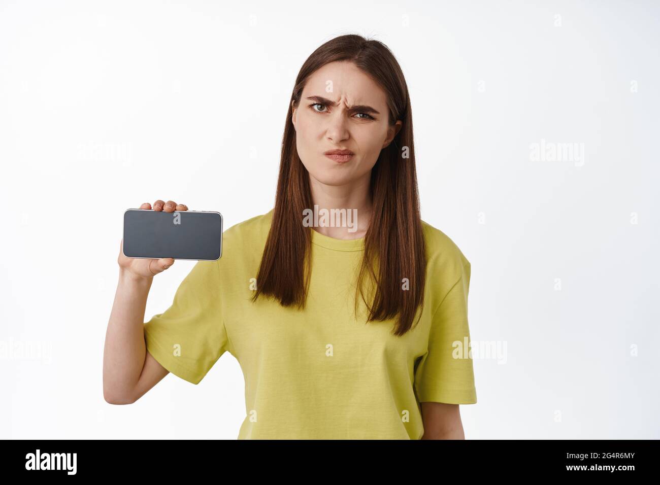 Very bad app. Displeased girl showing smartphone screen, interface and ...