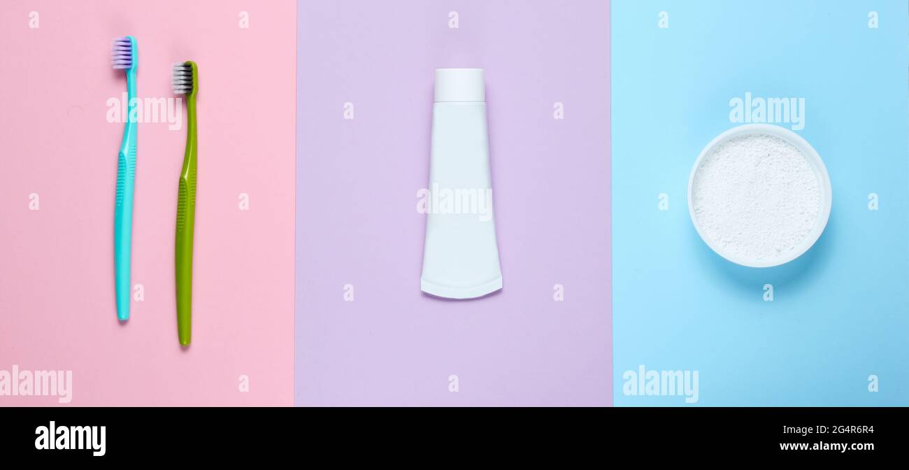 Minimalistic oral hygiene concept. Two toothbrushes with a tube of ...