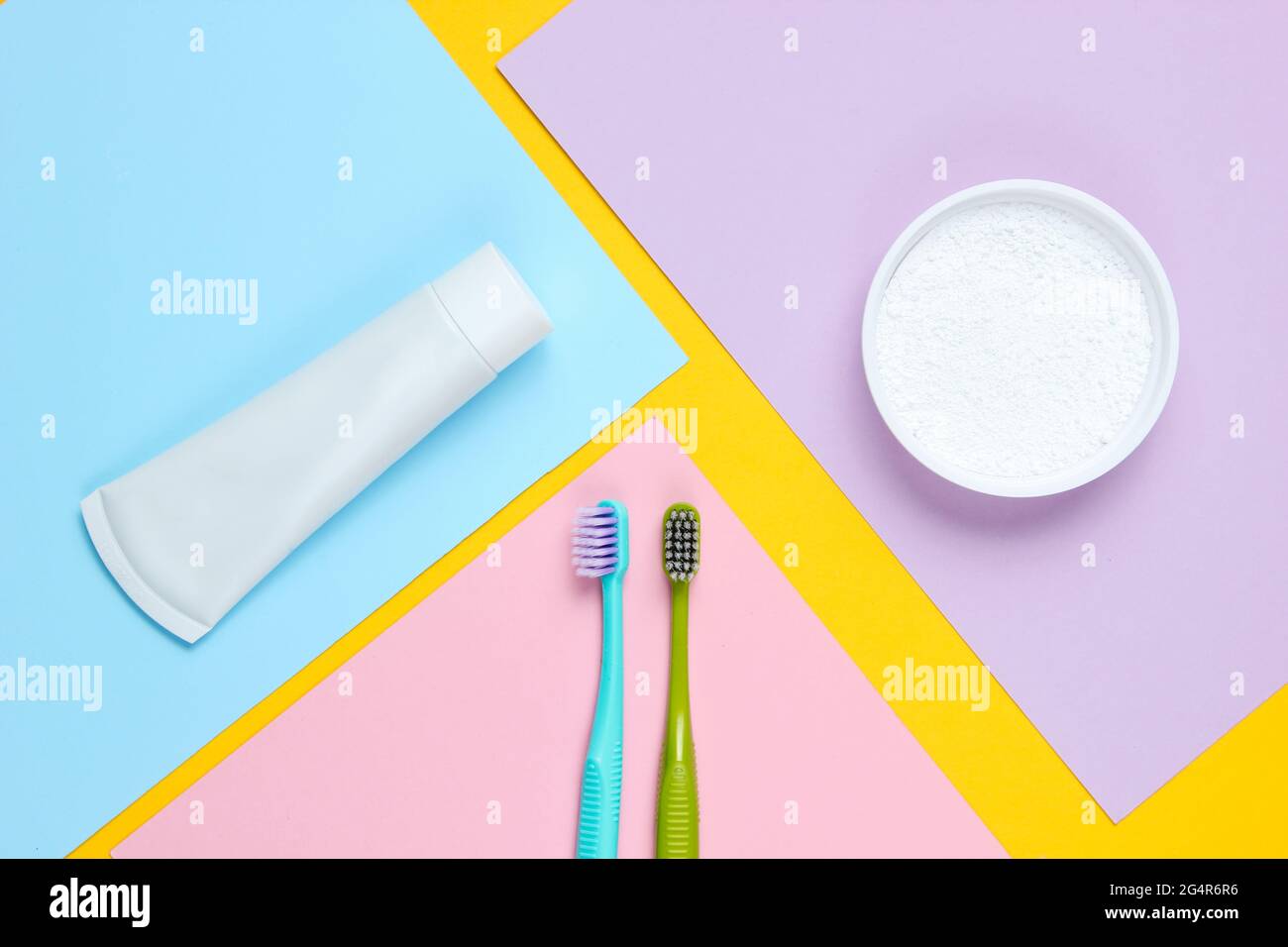 Minimalistic oral hygiene concept. Two toothbrushes with a tube of ...