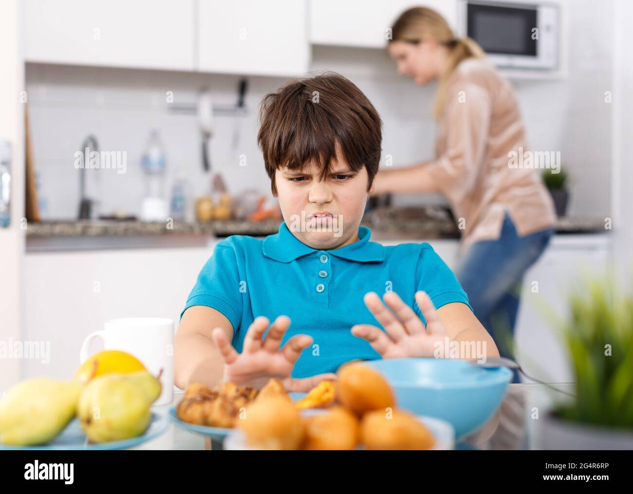 Displeased boy refusing to eat Stock Photo - Alamy