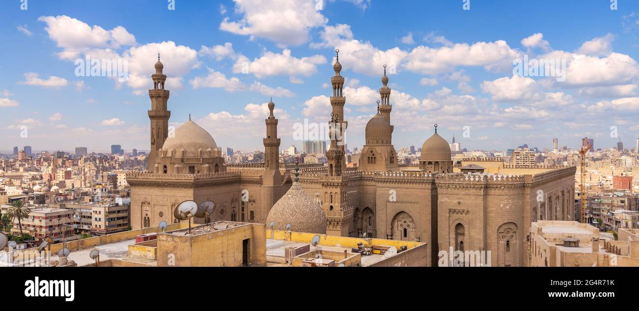 Aerial day shot of minarets and domes of Sultan Hasan mosque and Al Rifai Mosque mediating ...