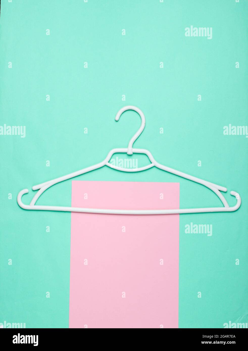 White plastic hanger on blue pink background. Top view Stock Photo - Alamy