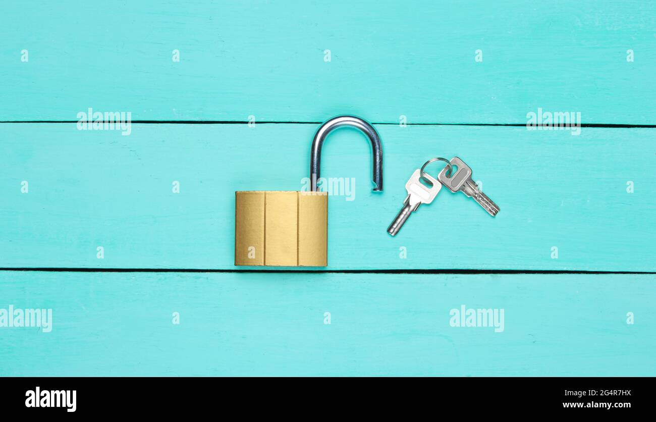 Lock and key on blue wooden background. Minimalistic concept. Top view ...