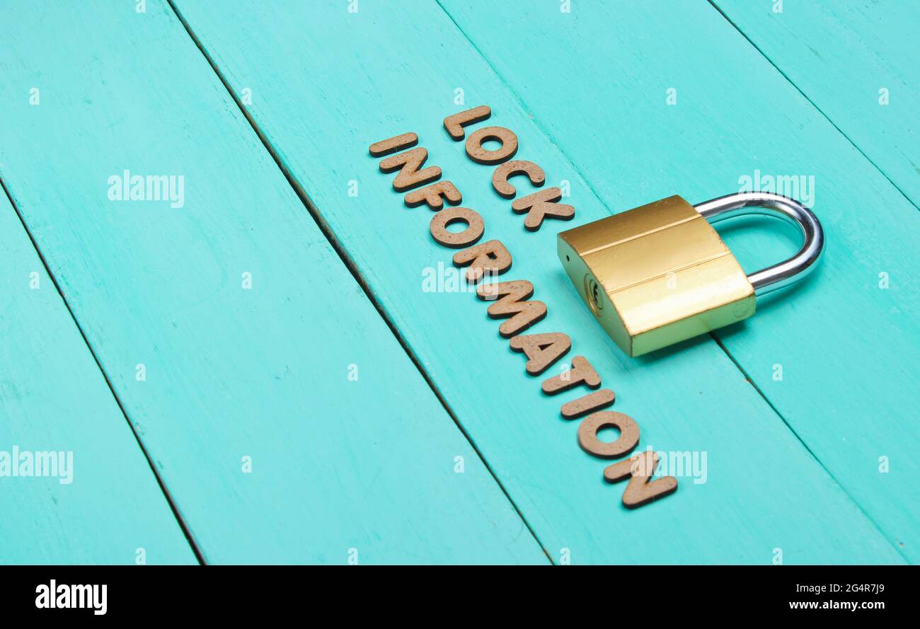 Lock your information. Lock on blue wooden background. Minimalistic ...