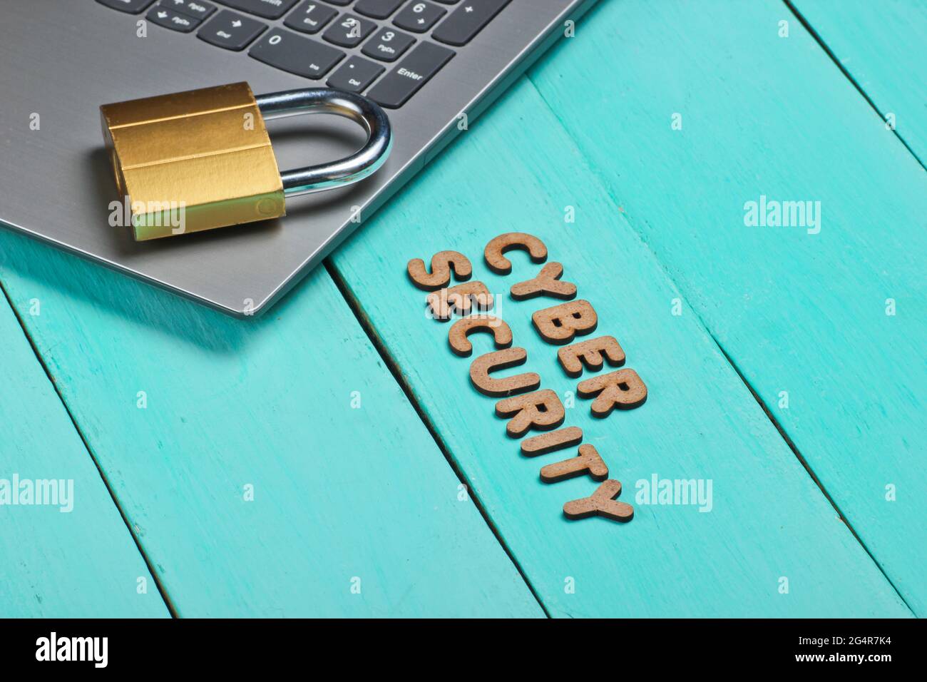 Cyber security. Laptop and Lock on blue wooden background. Minimalistic ...
