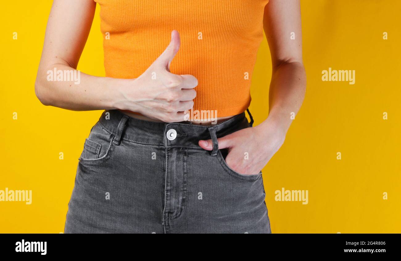 Woman showing thumb up gesture over yellow background. Crop photo ...
