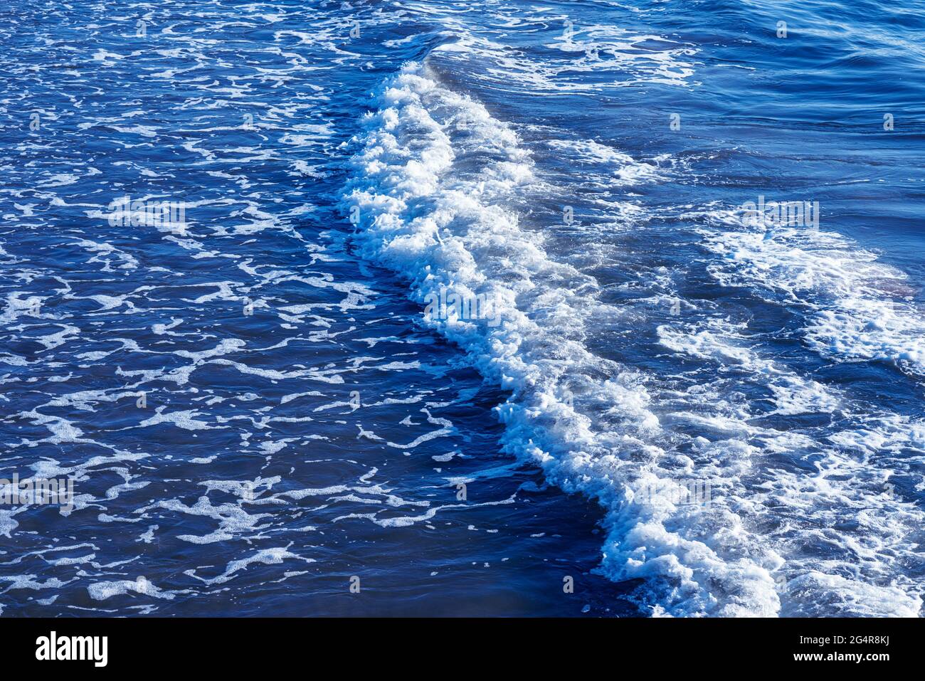 Areal shot of deep blue and rough sea with lot of sea spray.Blue ...